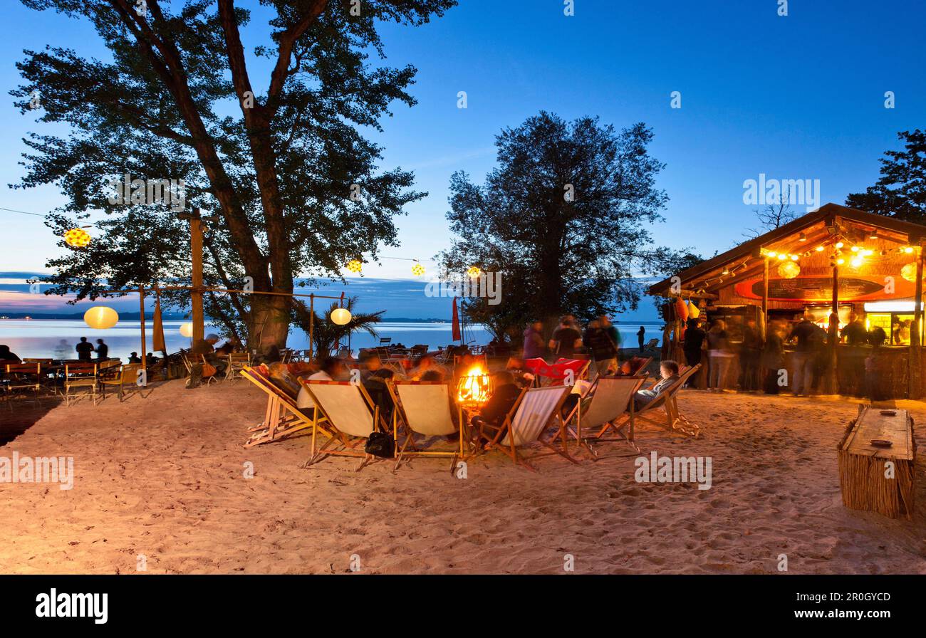 Guests in a beachbar in the evening, lido, Uebersee, lake Chiemsee ...