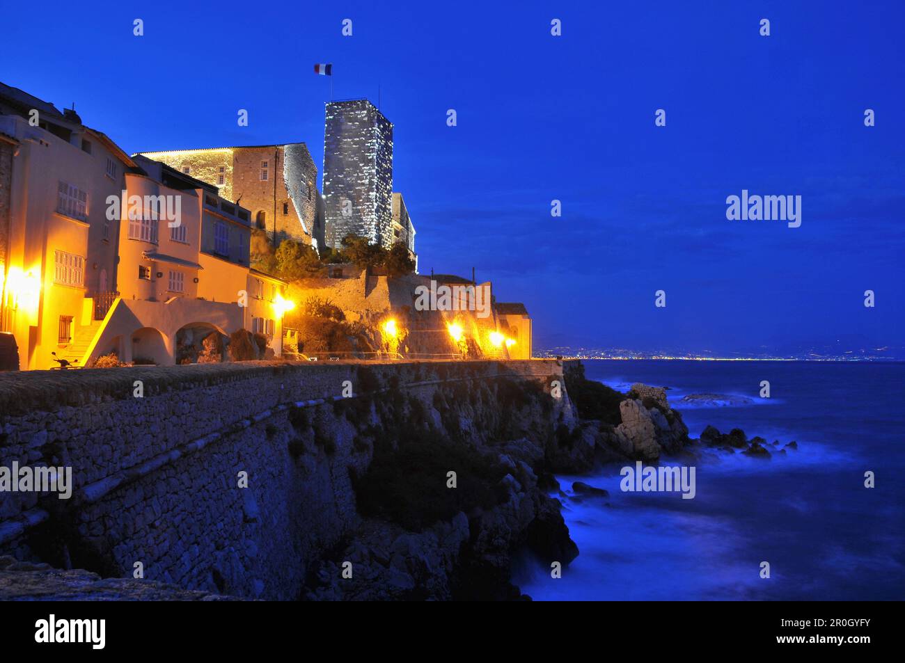 Illuminated old town and Chateau Grimaldi in the evening, Antibes, Cote ...