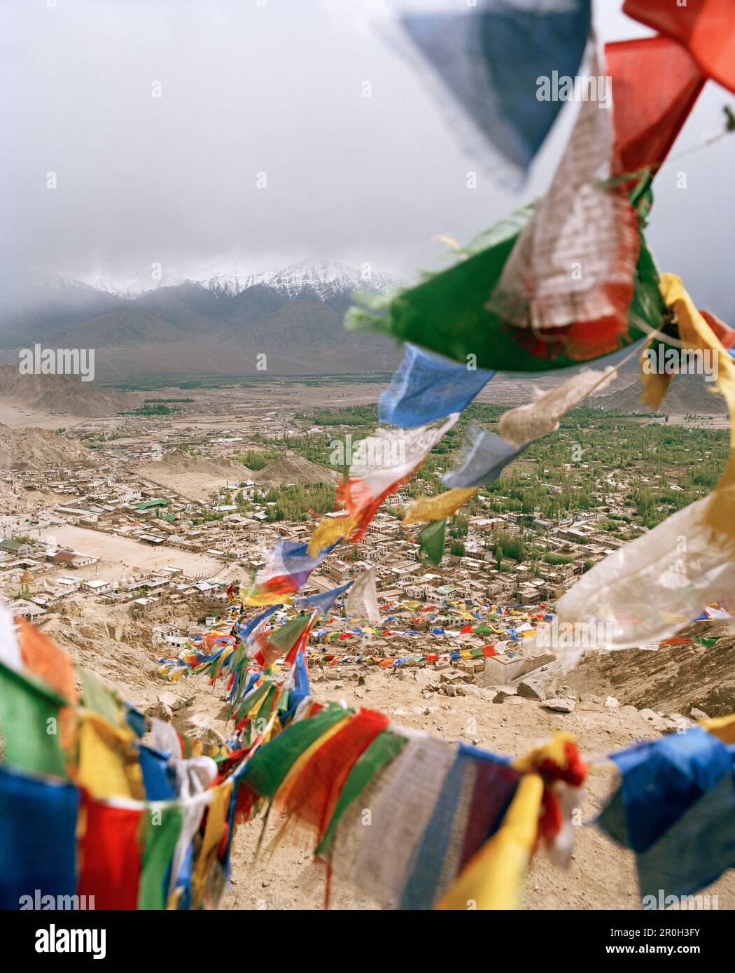 View through Buddhist prayer flags over capital Leh, Indus valley ...