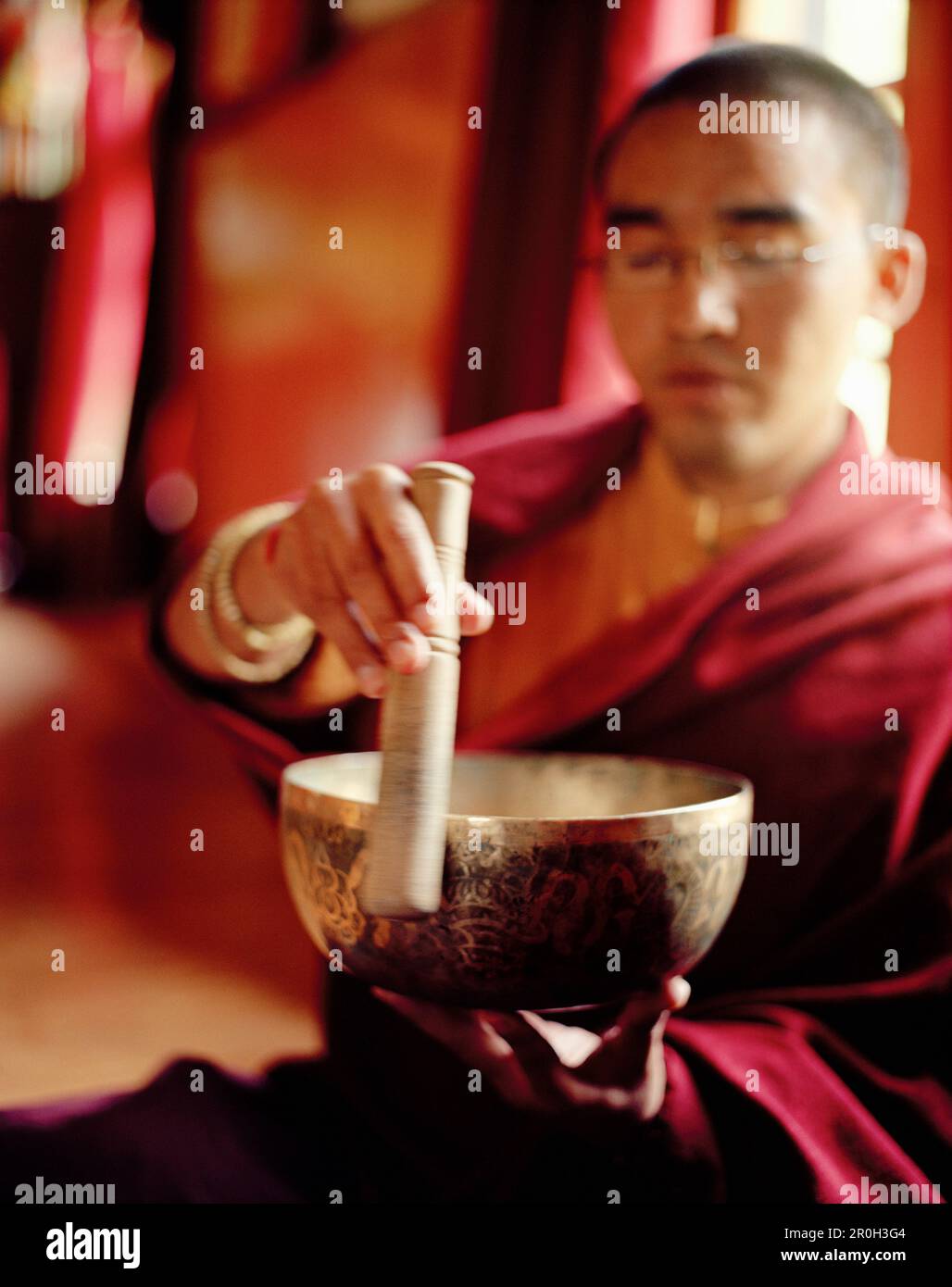 Monk Wangyal striking singing bowl and teaching concentration, convent ...