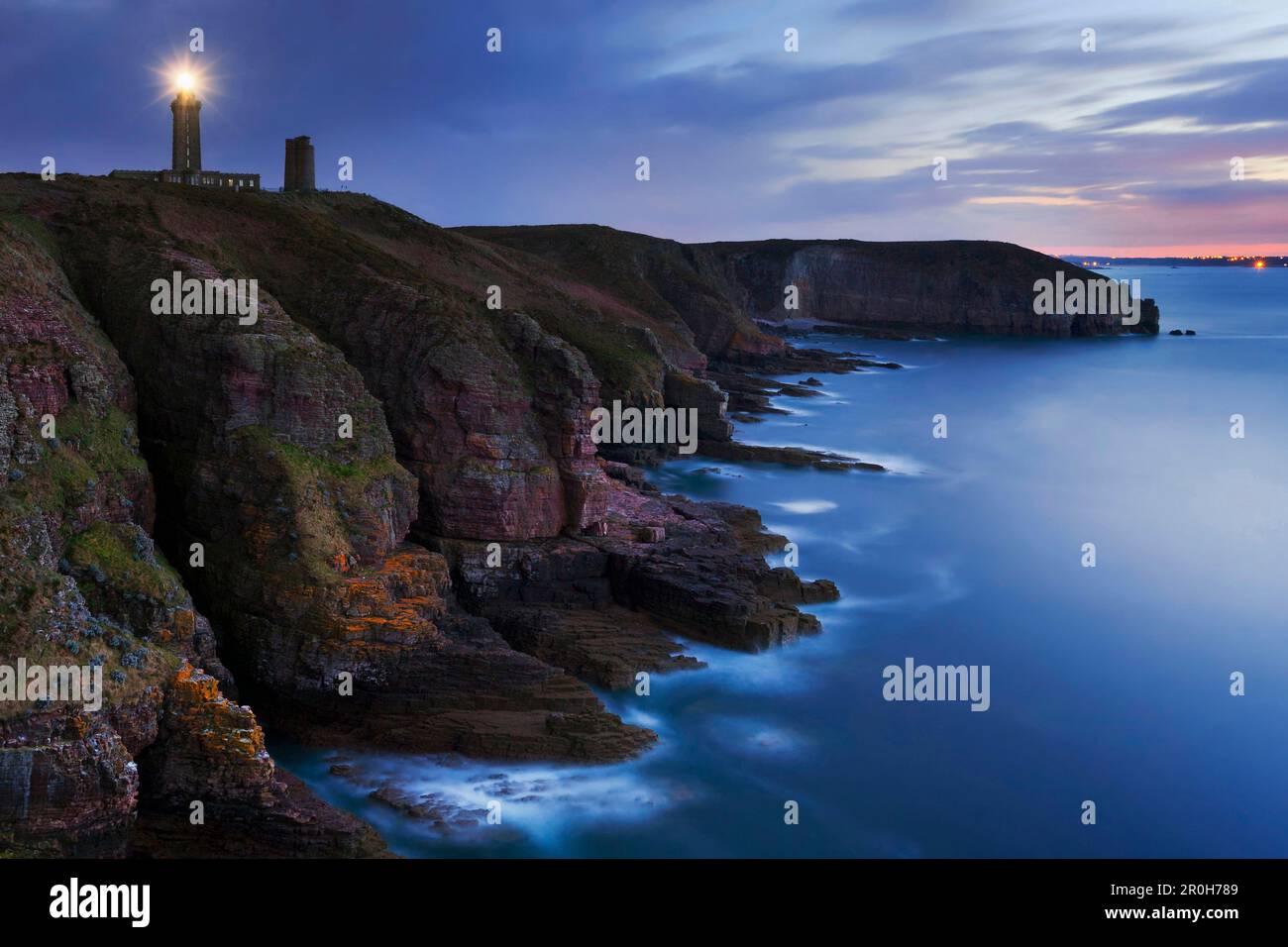 Cap Frehel lighthouse at the top of the 70-meter high cliffs in north ...