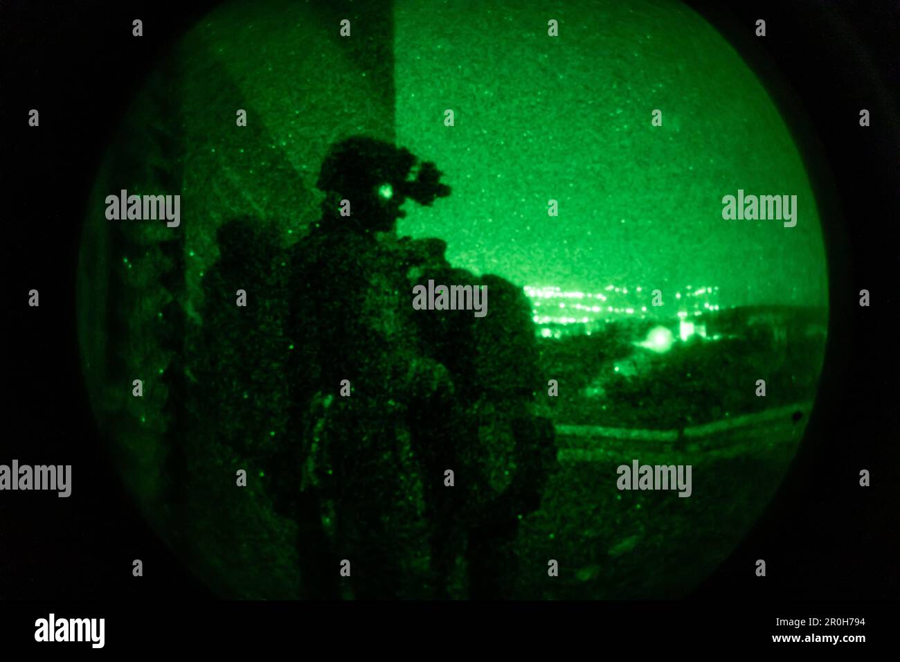 Special operations forces provide rear security during a mock raid ...