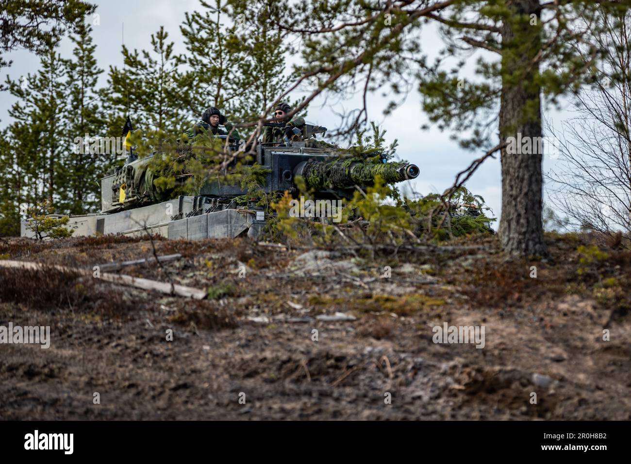 Finnish soldiers assigned to the Finnish Armoured Brigade, maneuver a ...