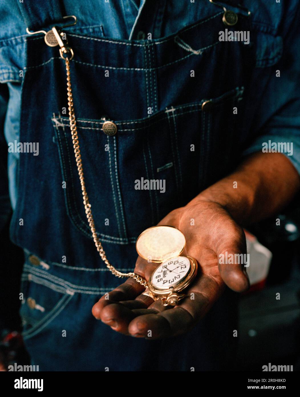 USA, Connecticut, mid section of a train engineer showing pocket watch ...