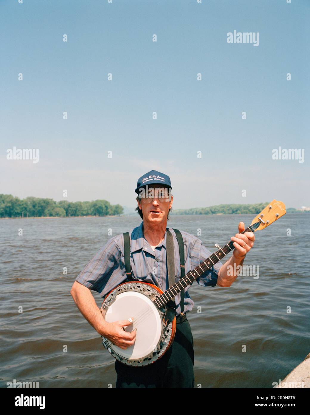 USA, Minessota, Lacrosse, portrait of mature man playing banjo against ...