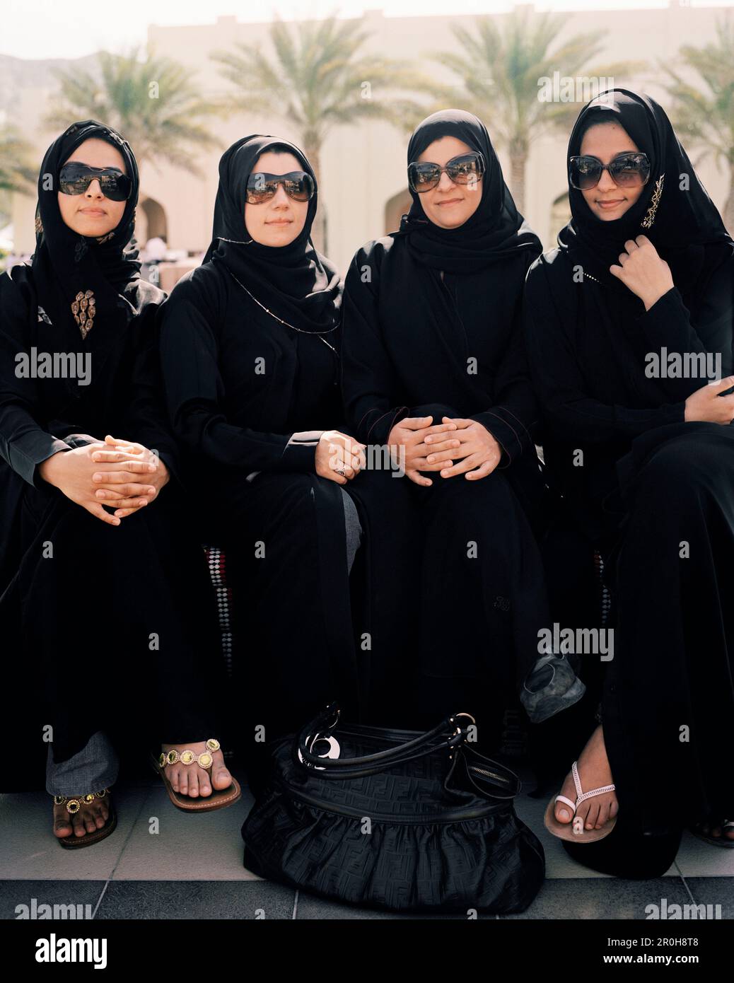 OMAN, Muslim women sitting side by side in traditional clothing at the ...