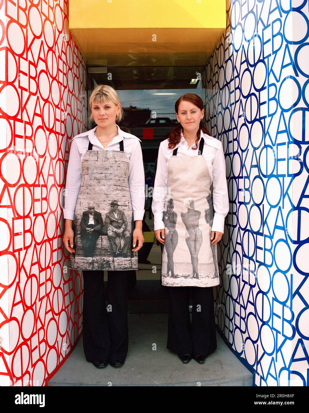 RUSSIA, Moscow, young waitresses at the front door of the Book Cafe ...