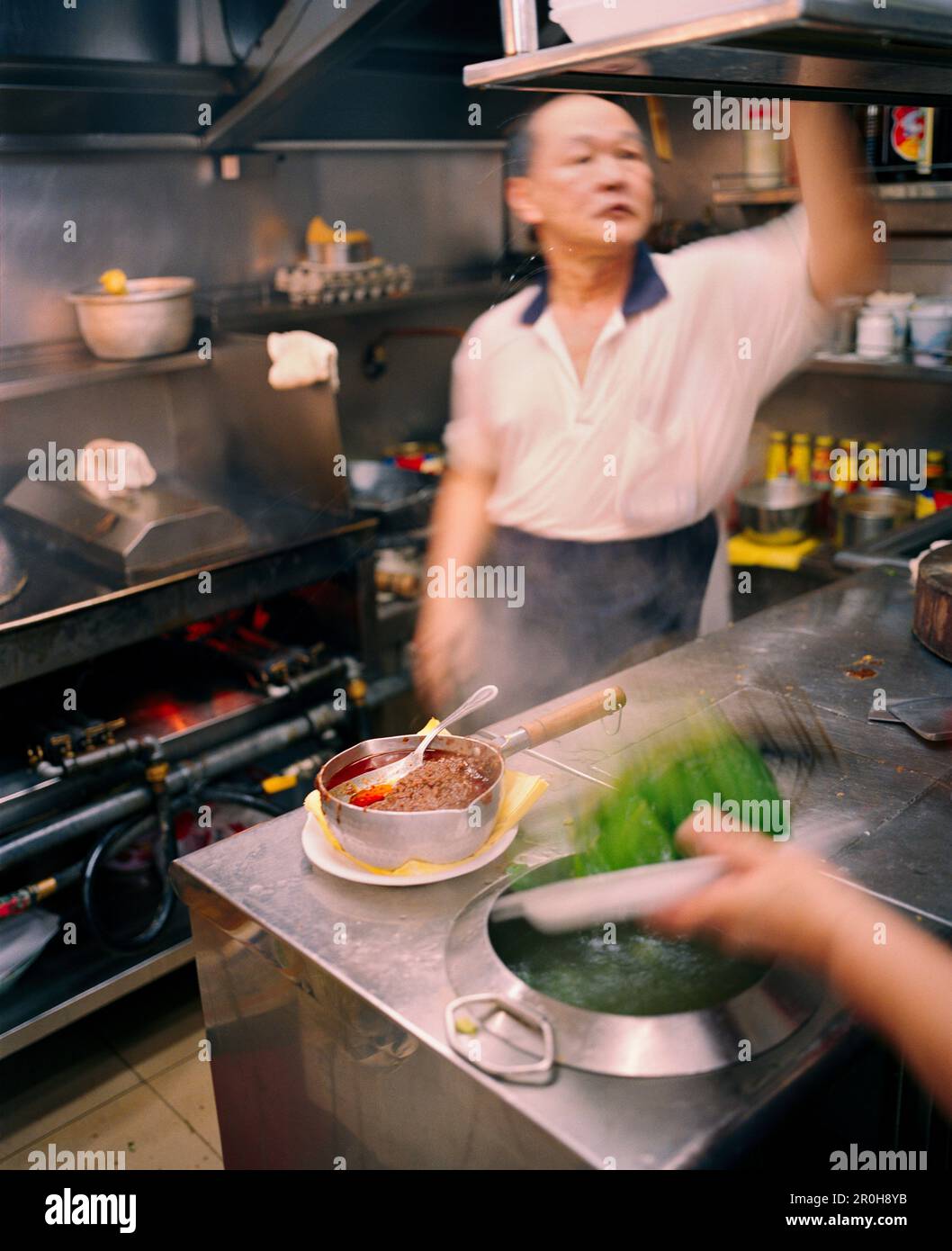 SINGAPORE, Asia, chef working at the Newton Food Court kitchen Stock ...