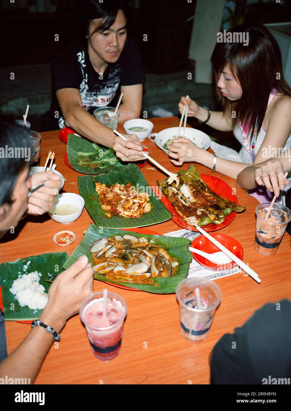 SINGAPORE, Asia, group of people eating dinner at Chinatown restaurant ...