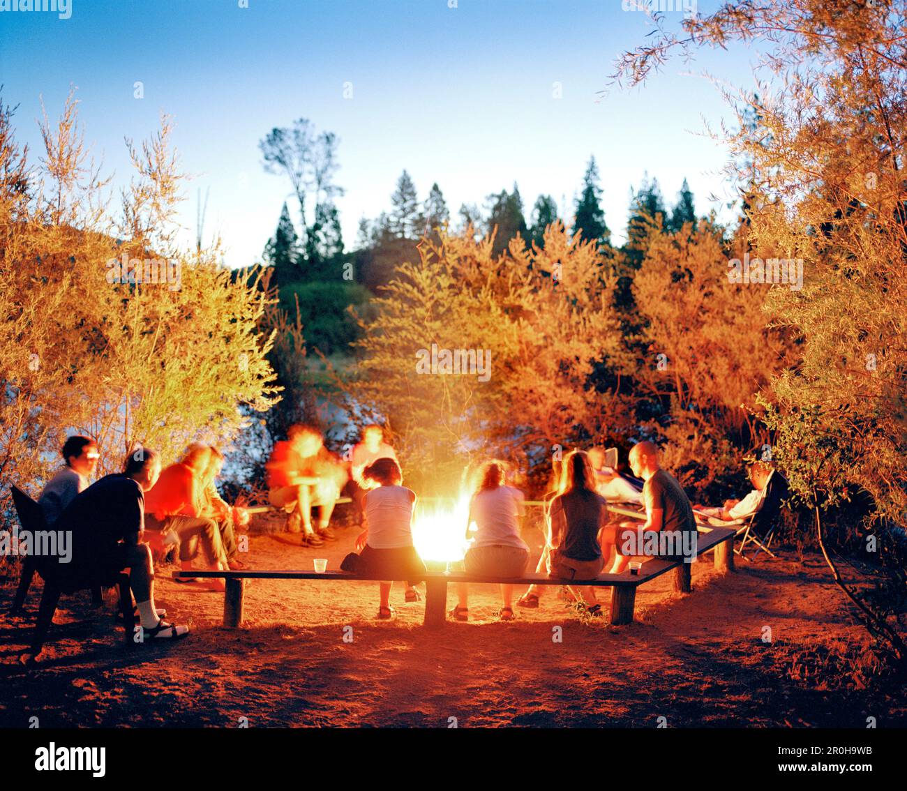 USA, CALIFORNIA, friends around campfire, South Fork of the American ...