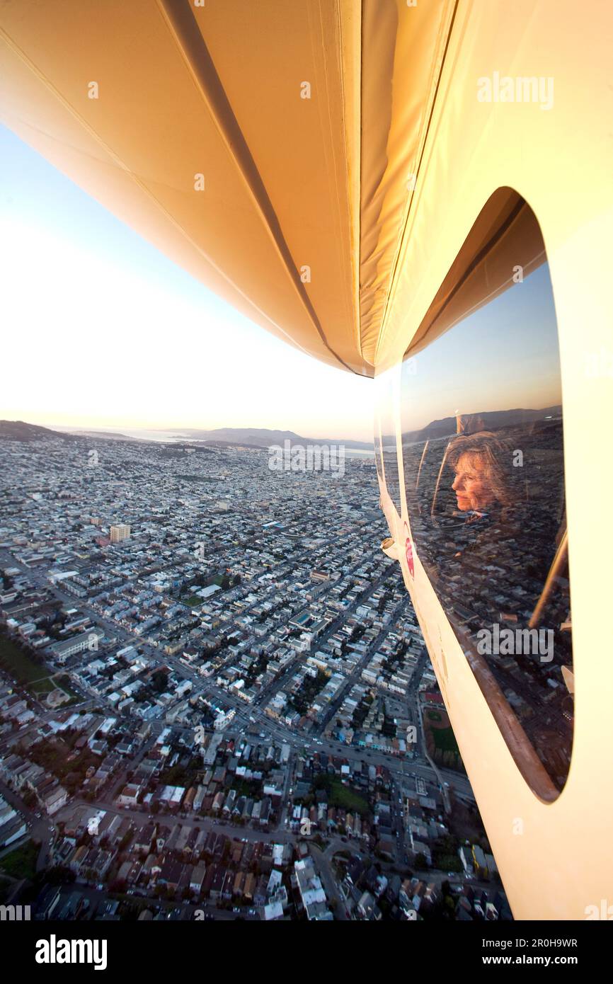 USA, California, San Francisco, woman looking out the window of the ...