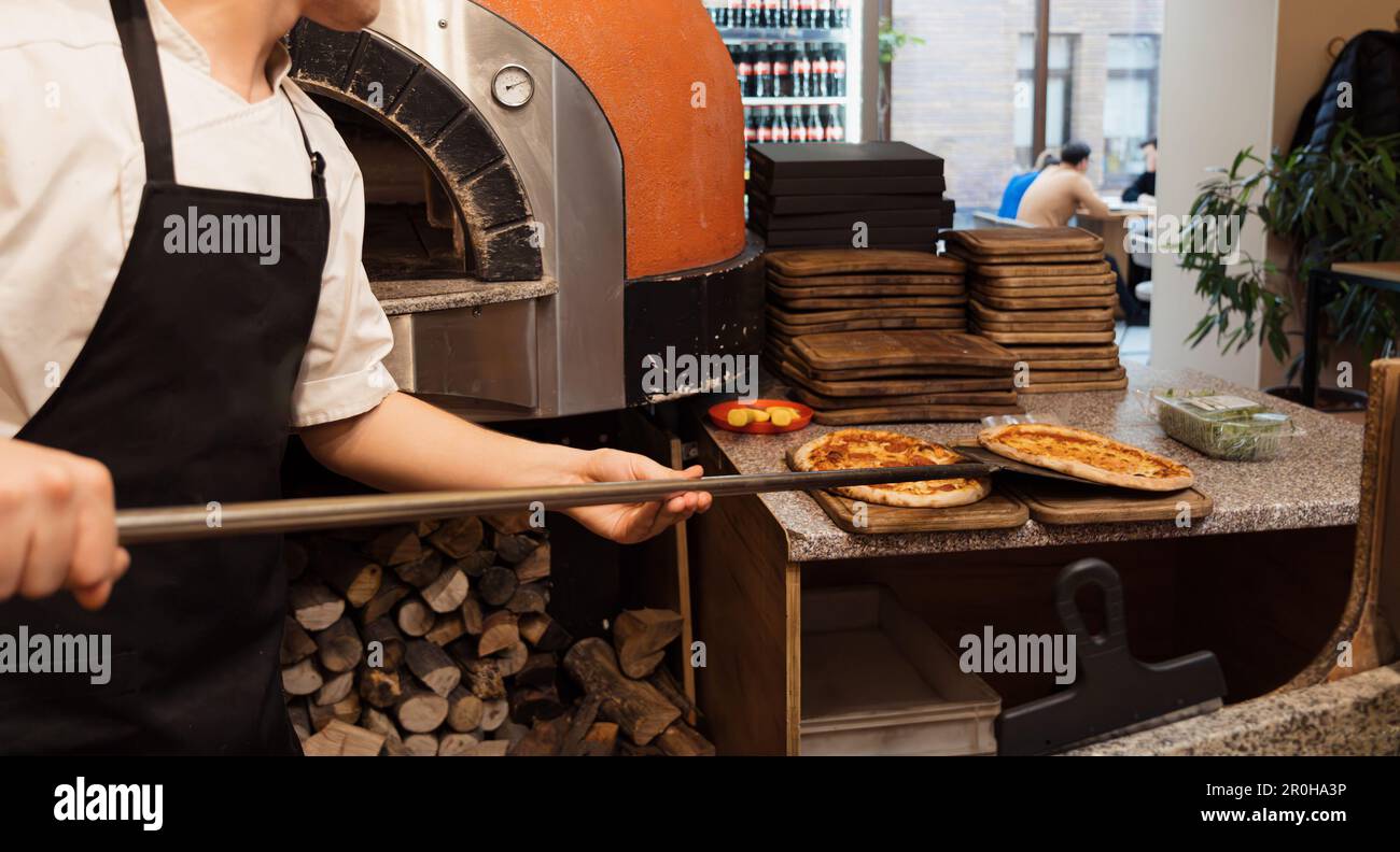 Preparing traditional italian pizza in a professional oven with open ...