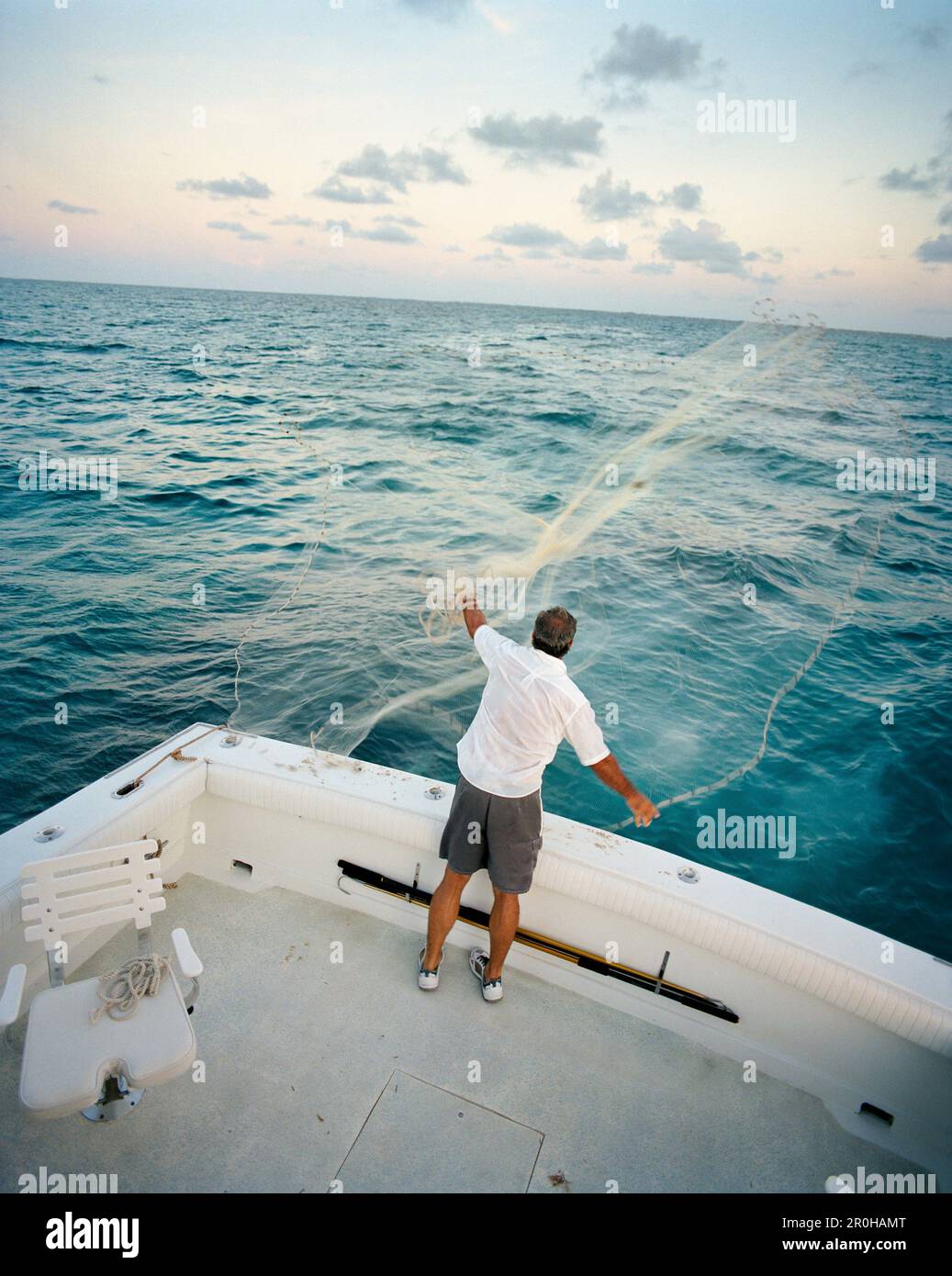 USA, Florida, fisherman on the Fish Tales casting a net, elevated view ...