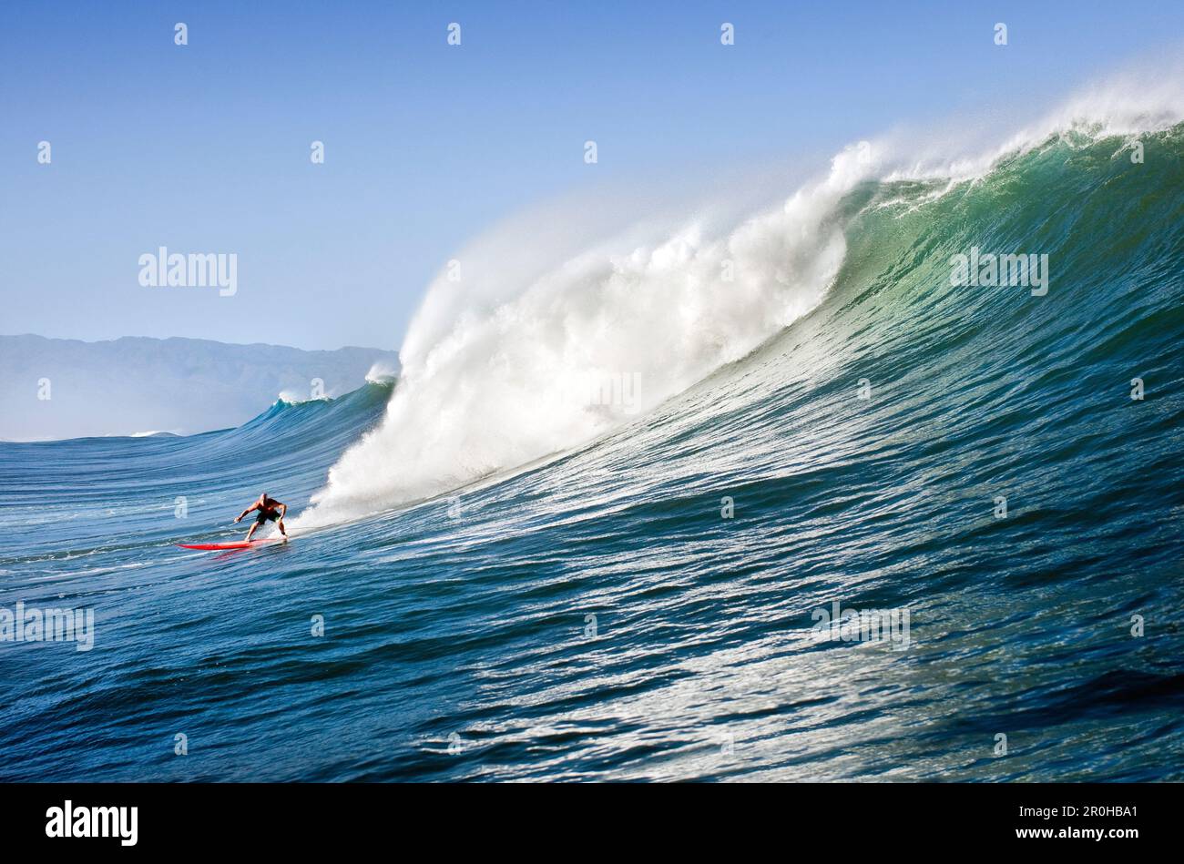 USA, Hawaii, man surfs a large wave on an outer reef, the North Shore ...