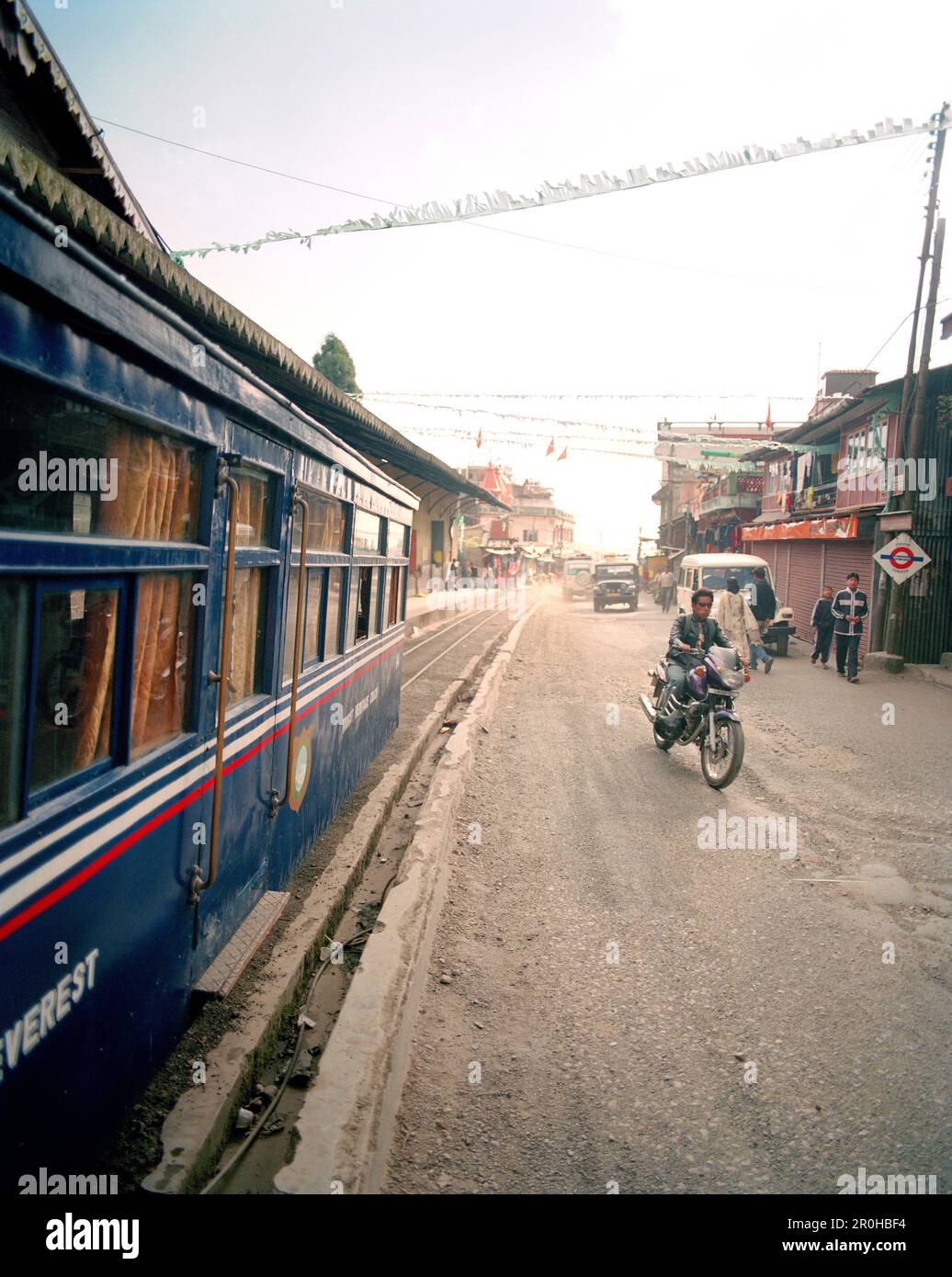 INDIA, West Bengal, man riding motorcycle by train, Darjeeling Stock ...