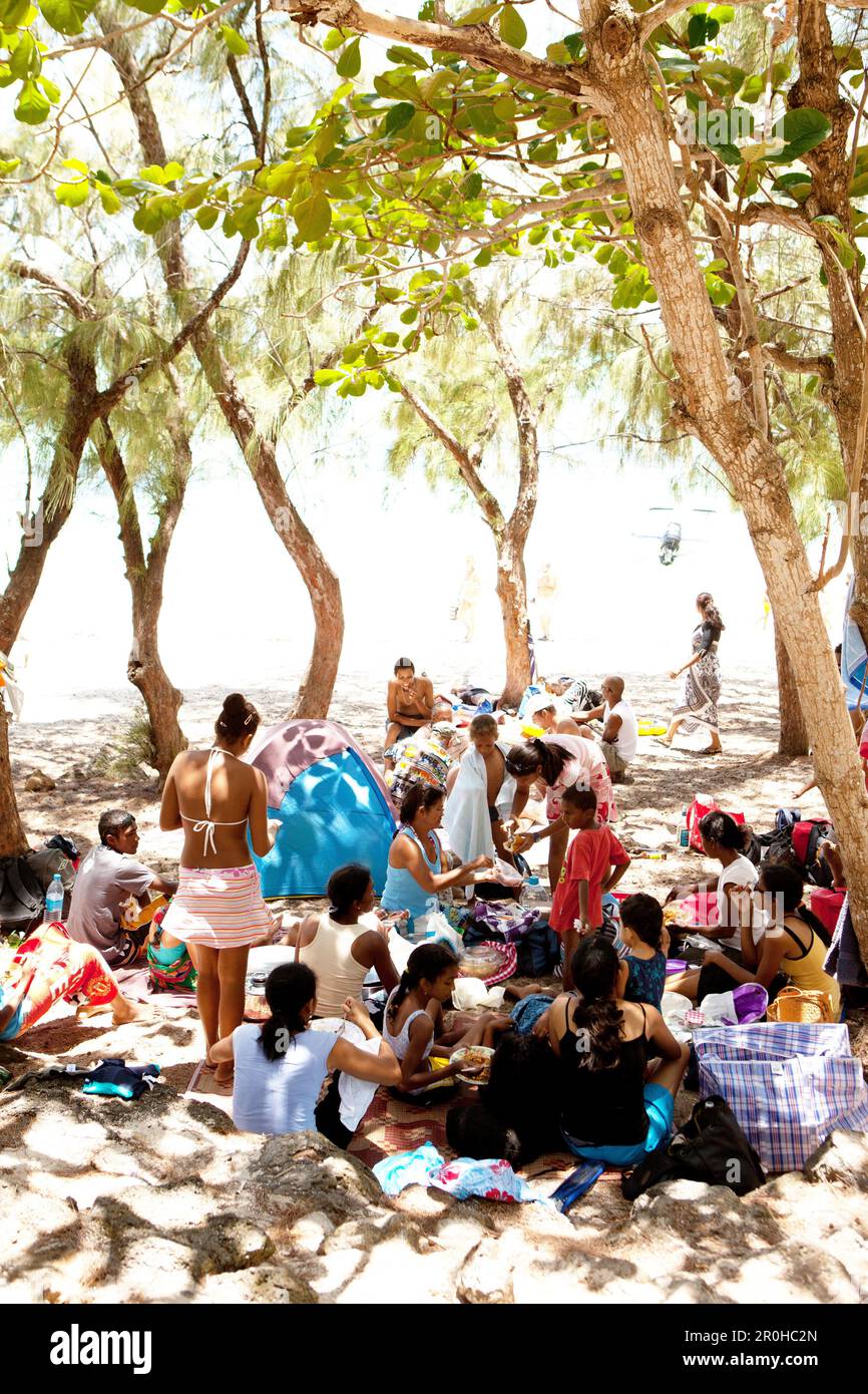 MAURITIUS, friends are enjoy some shade and a picnic on the beach at ...