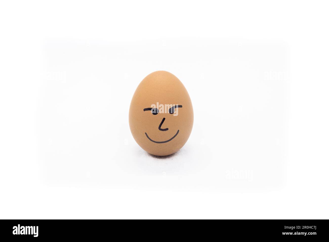 A white egg with a cheerful smiley face drawn in black marker Stock ...