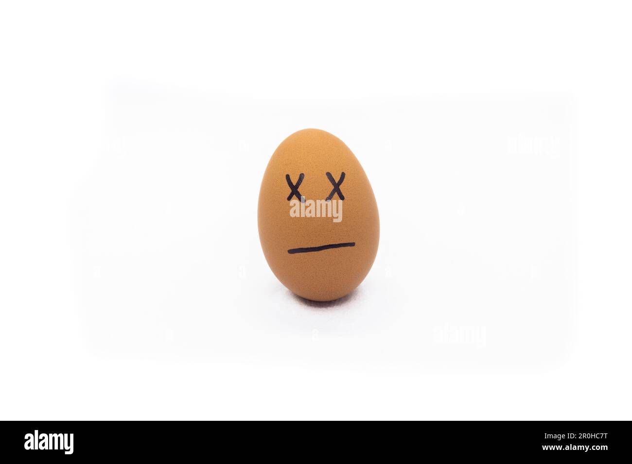 An isolated, white egg with a sad facial expression hand-drawn onto the ...
