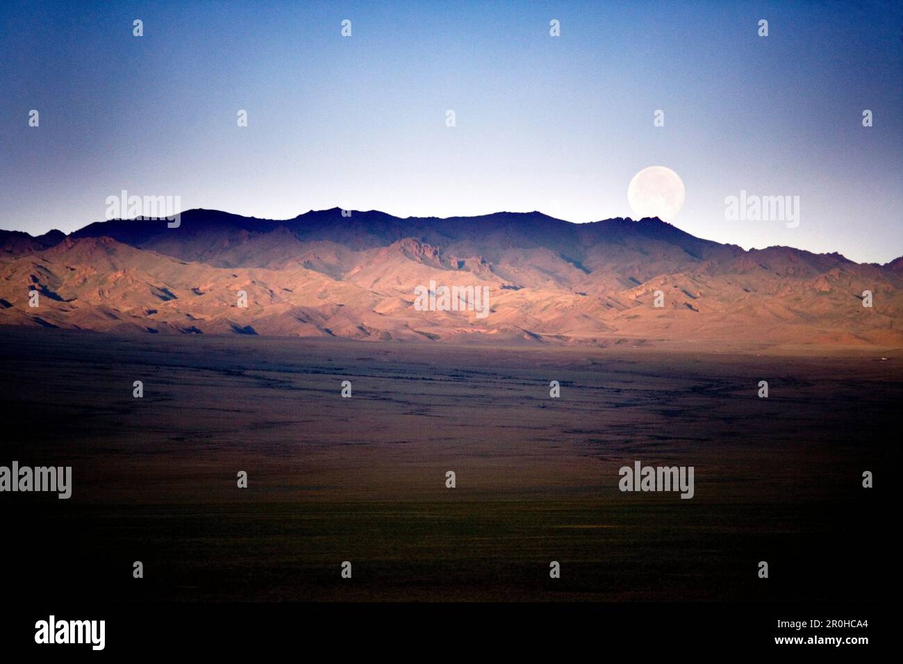 MONGOLIA, Gobi Desert, barren landscape under the setting full moon in ...