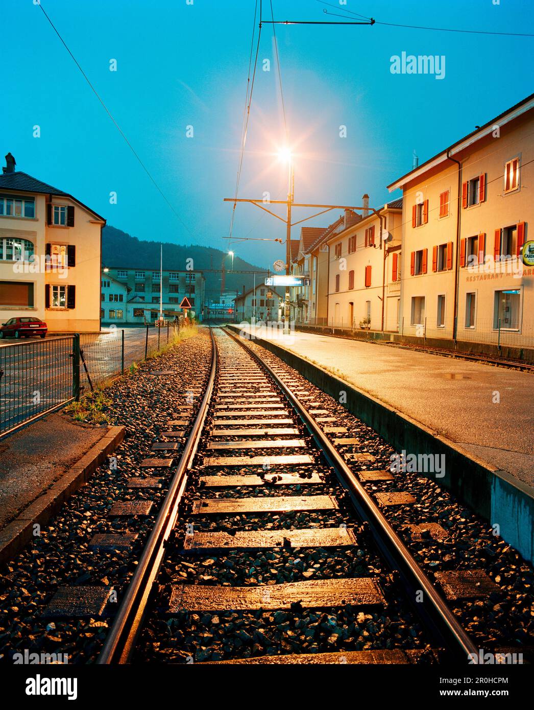 SWITZERLAND, Couvet, the train station at dusk, Jura Region Stock Photo ...