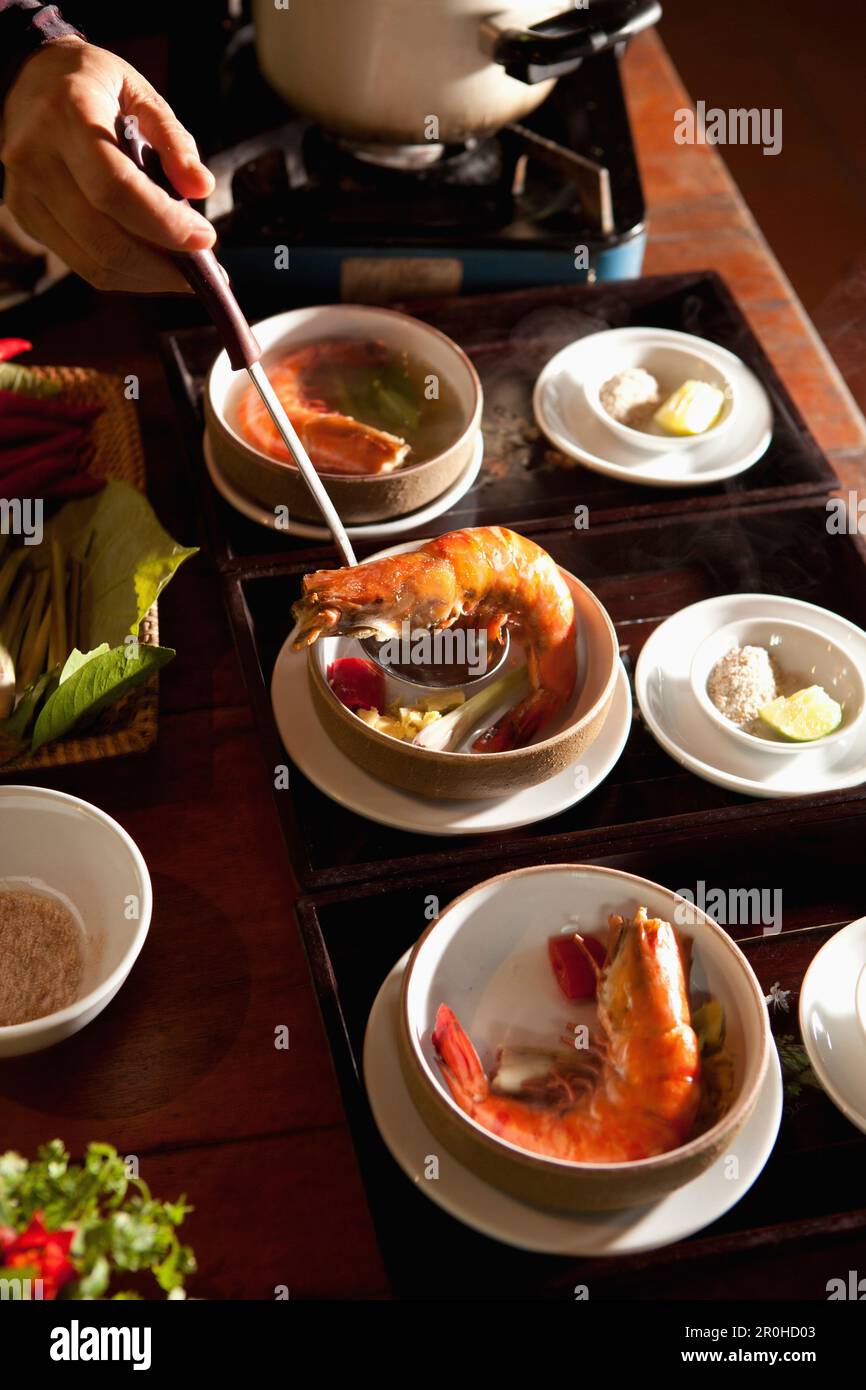 VIETNAM, Hue, Ms. Boi Tran serves a dish she calls Shrimp with five ...