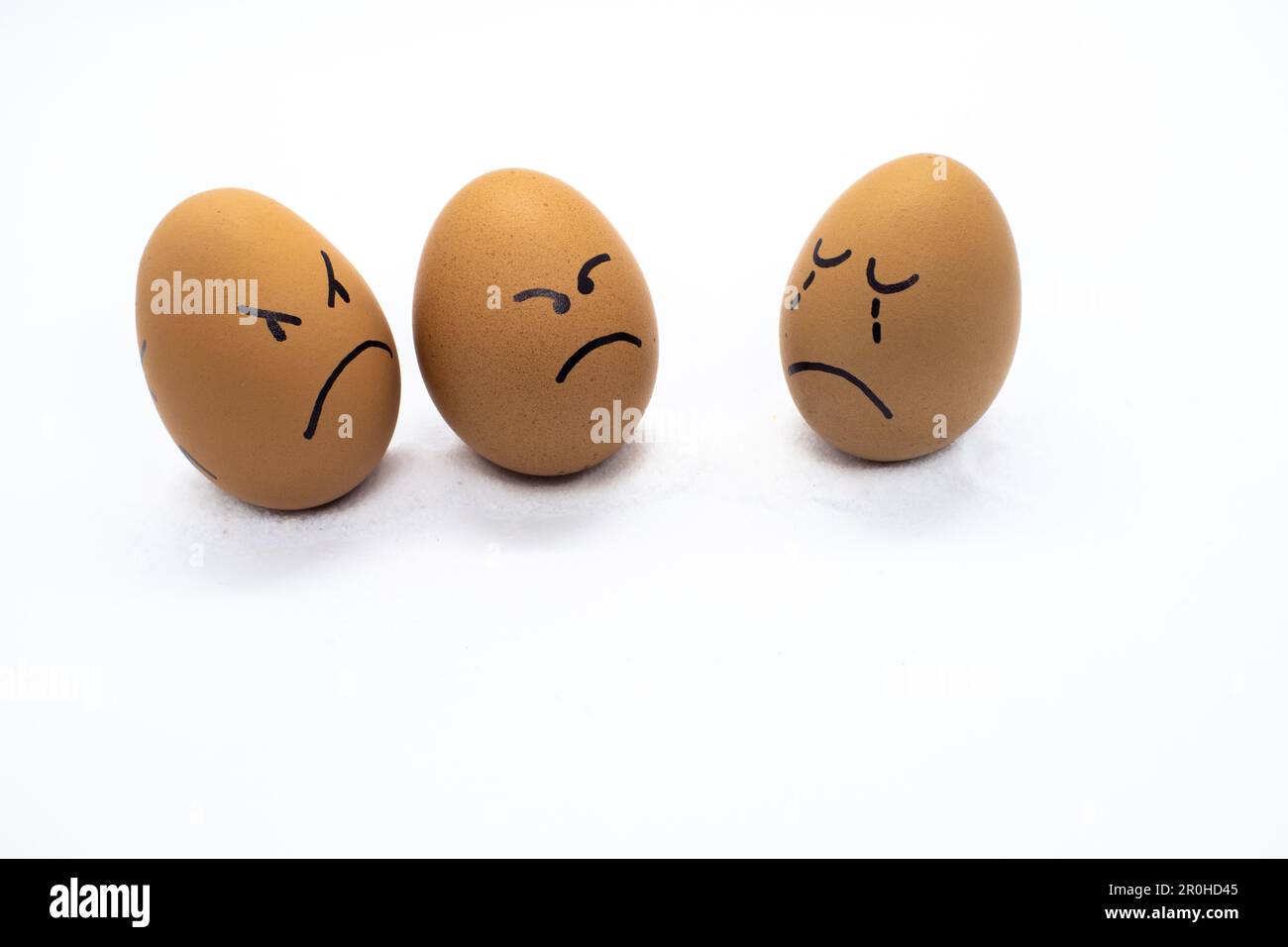 A collection of multicolored eggs with human facial features drawn upon them, arranged in a ...