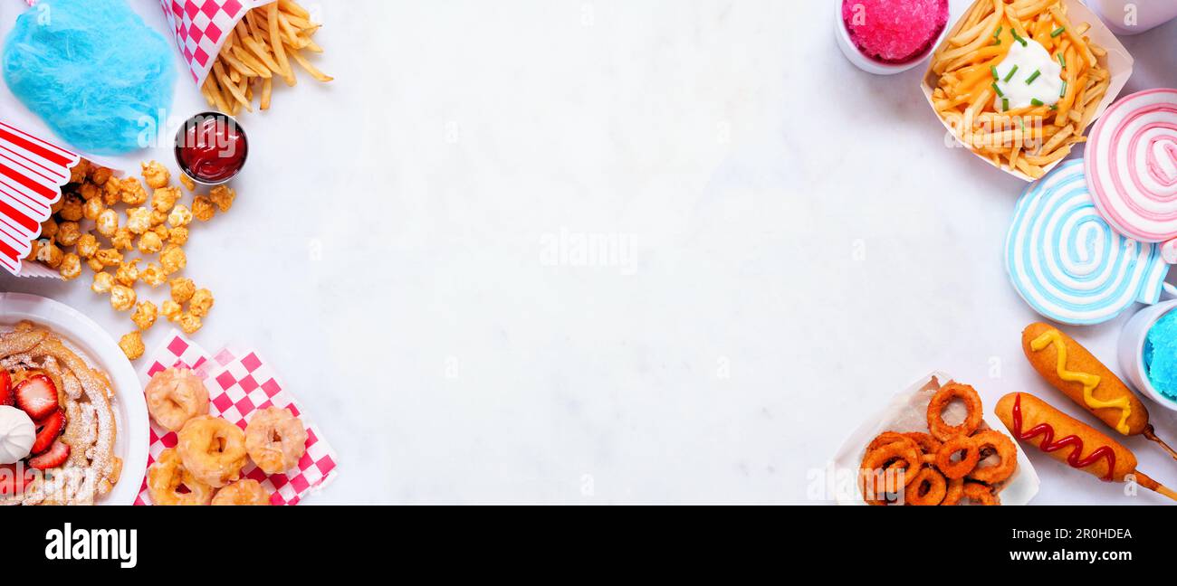 Carnival theme food double border on a white marble background. Top ...