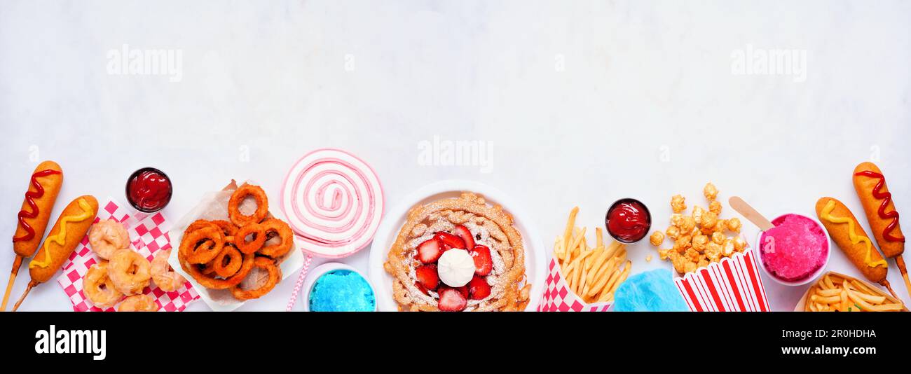 Carnival theme food bottom border on a white marble background. Top ...