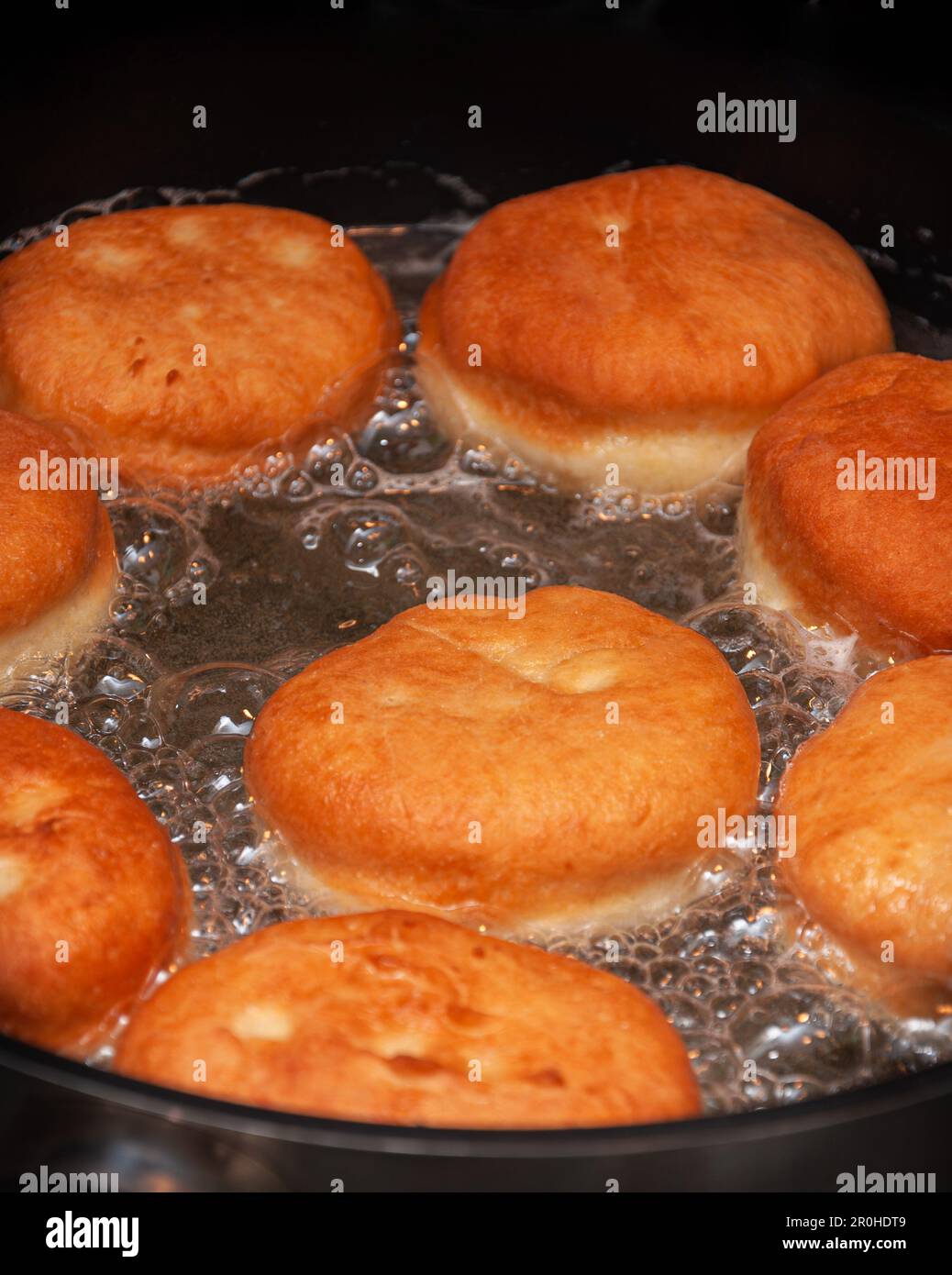 Traditional homemade polish donuts. Oil frying process Stock Photo - Alamy