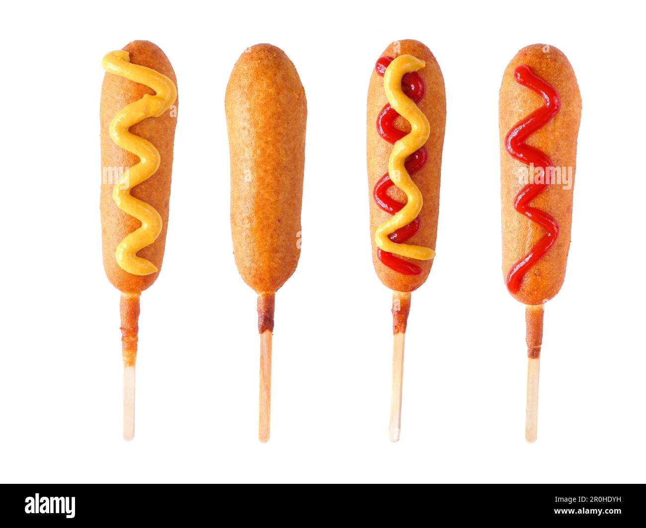Four corn dogs with different toppings isolated on a white background ...
