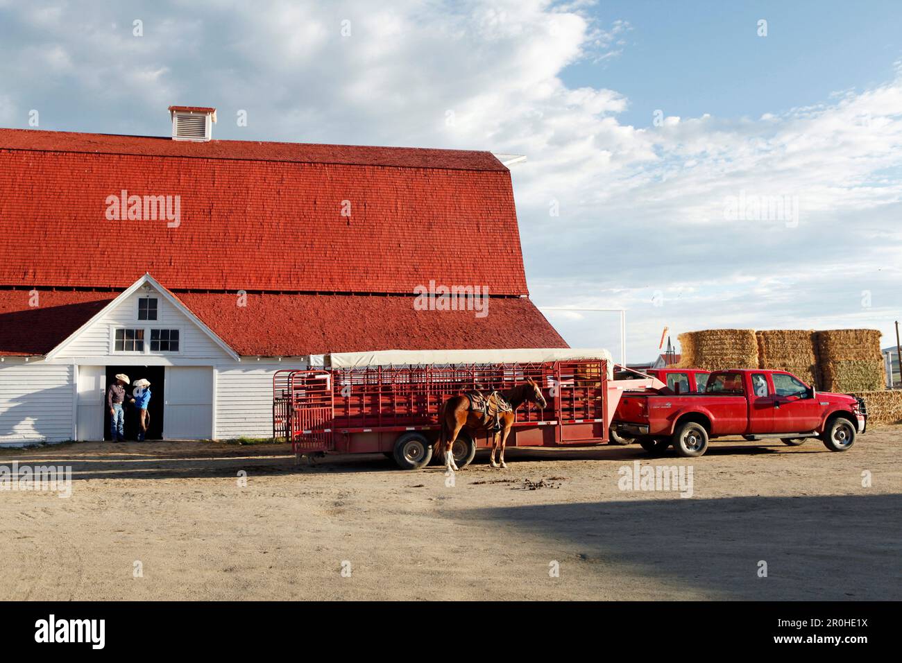 USA, Wyoming, Encampment, a cowboy and cowgirl stand in the doorway of ...