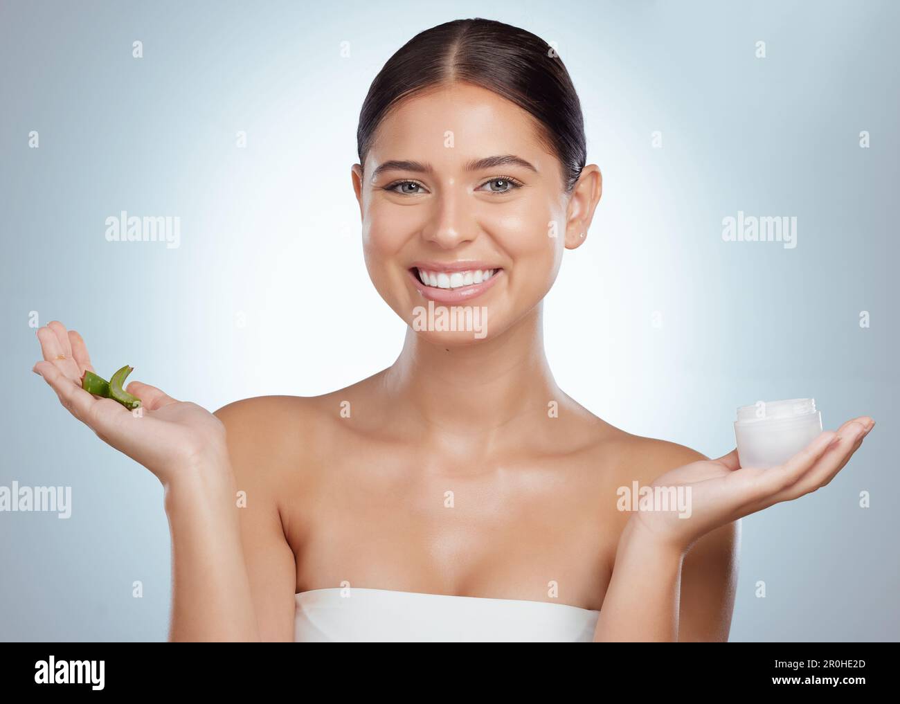 Portrait of smiling beautiful woman using aloe vera in skincare routine ...
