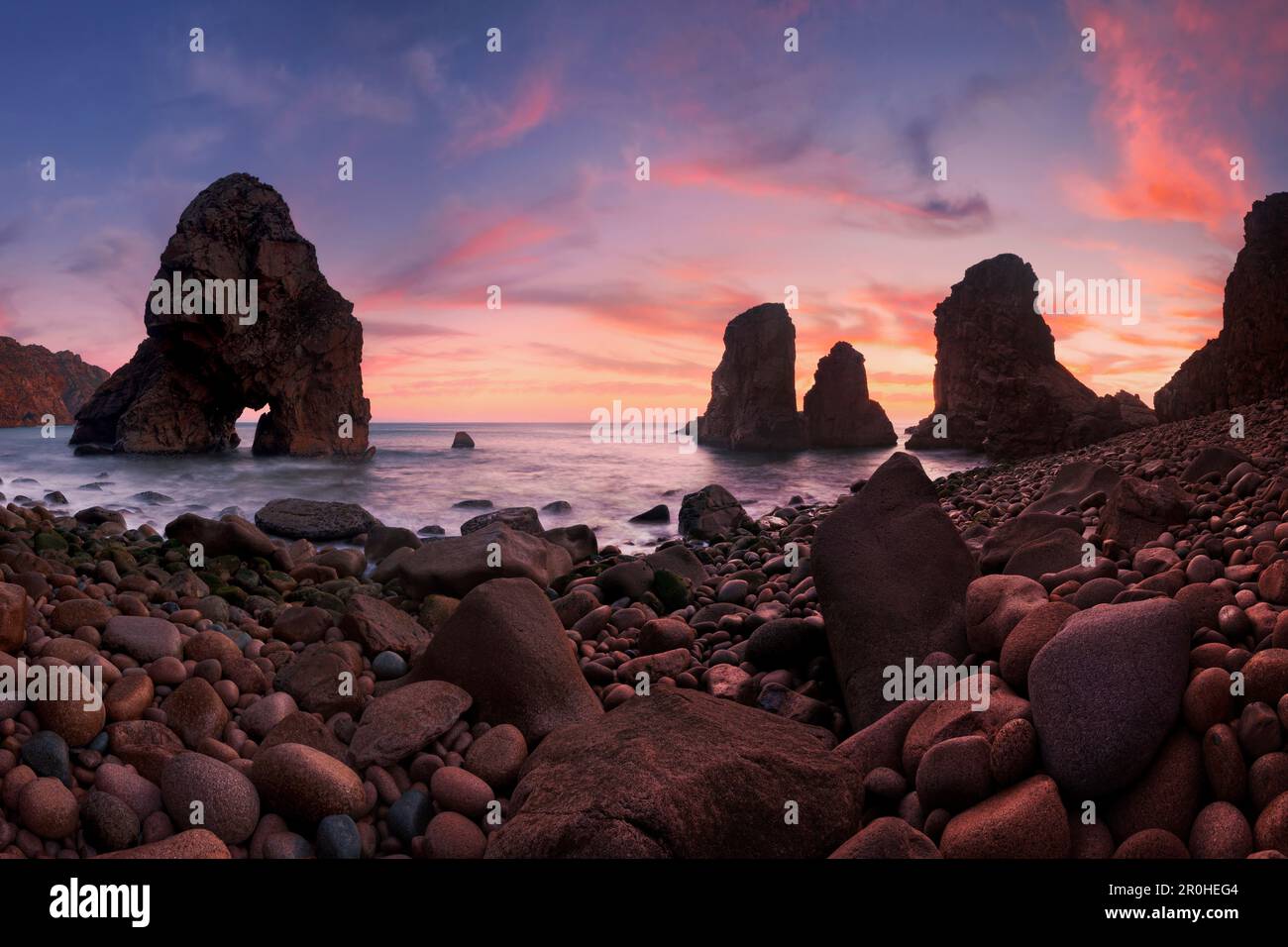 A reddish blaze of colors right after sunset above the rock formations ...