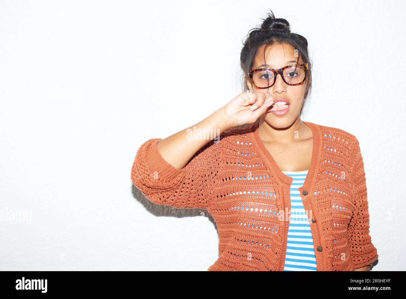 Asian girl biting finger hi-res stock photography and images - Alamy