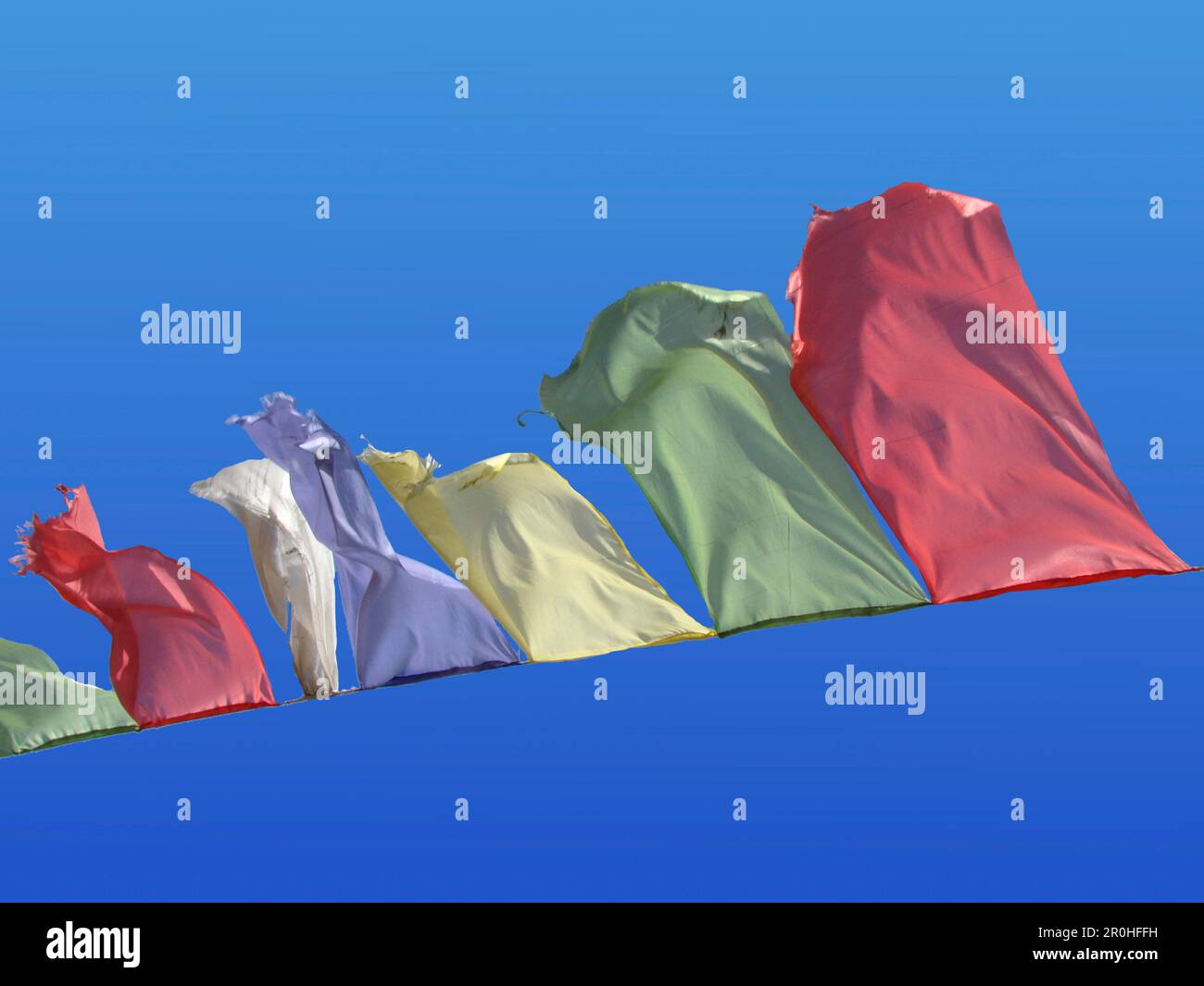 Prayer flags in various colors against the blue sky as a lucky cham ...