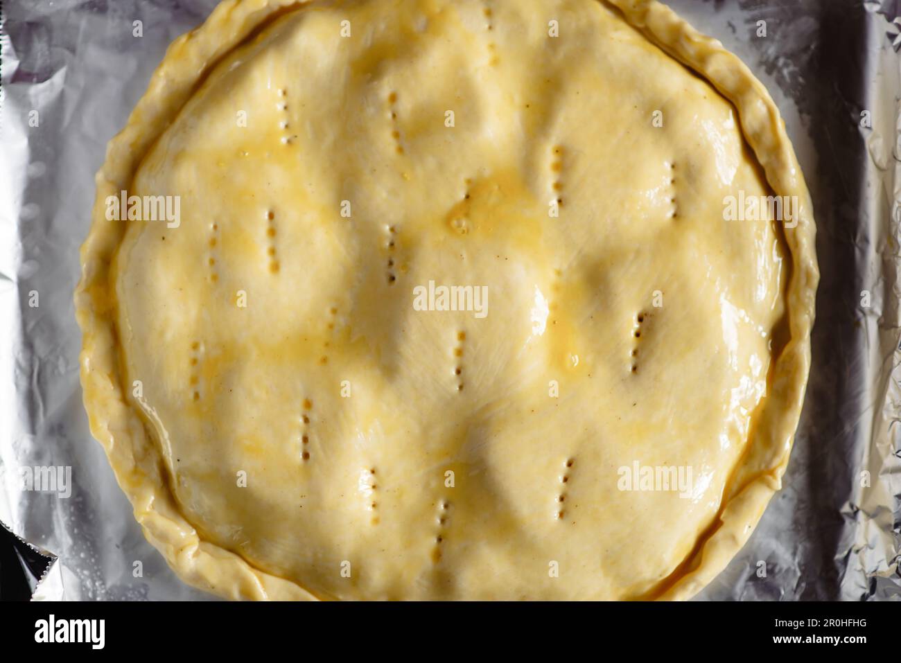 making a closed pie. Round raw pie on a baking sheet. Spread with ...