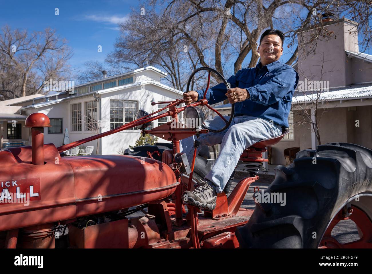 Hispanic Male Poses on Red Tractor at Los Poblanos Ranch in Albuquerque ...