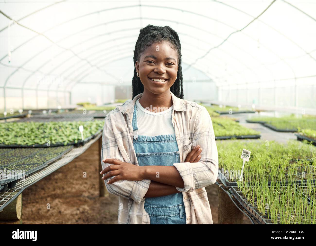 Portrait of a proud farmer. Powerful woman working in her greenhouse ...