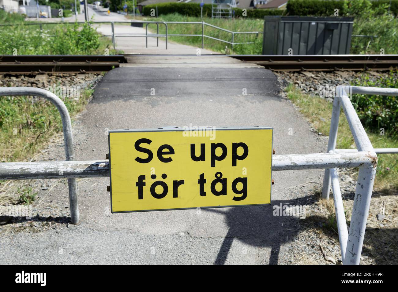 Passage over Train Tracks with a Warning sign in Swedish Stock Photo ...