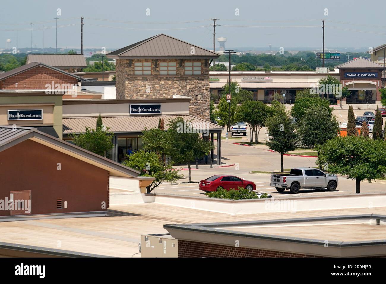 A view of the Allen Premium Outlets mall shows a mostly-empty parking ...
