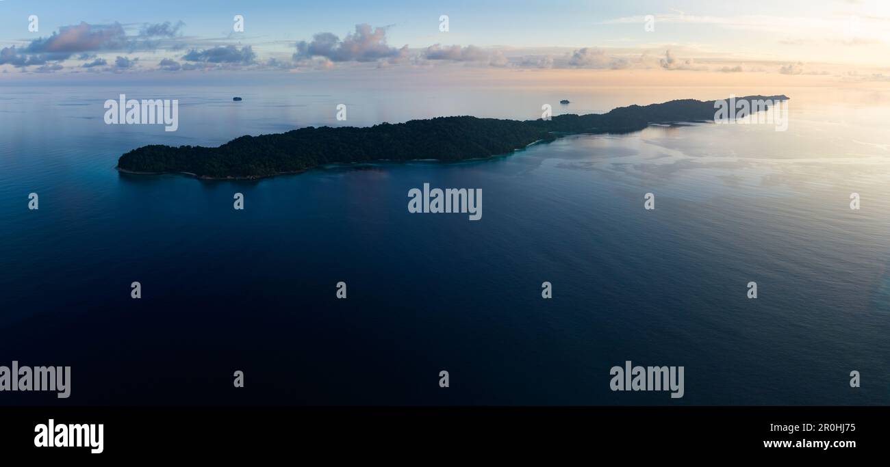 Coral reefs surround the rugged limestone islands that rise from West ...
