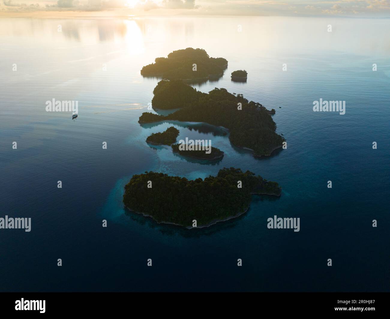 Coral reefs surround the rugged limestone islands that rise from West ...