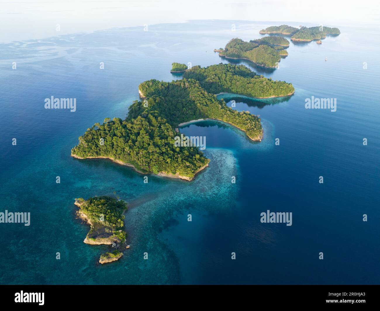 Coral reefs surround the rugged limestone islands that rise from West ...