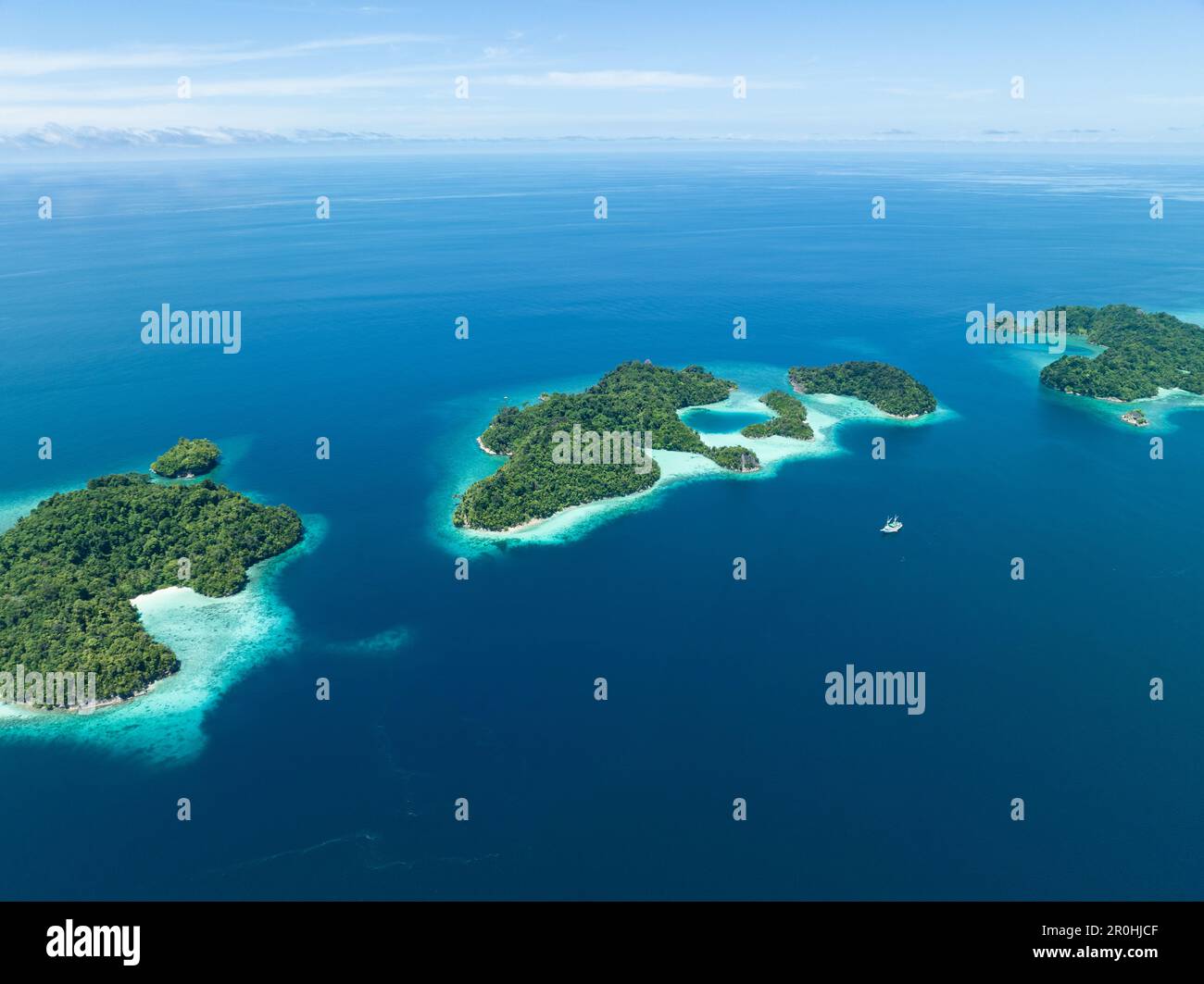 Coral reefs surround the rugged limestone islands that rise from West ...