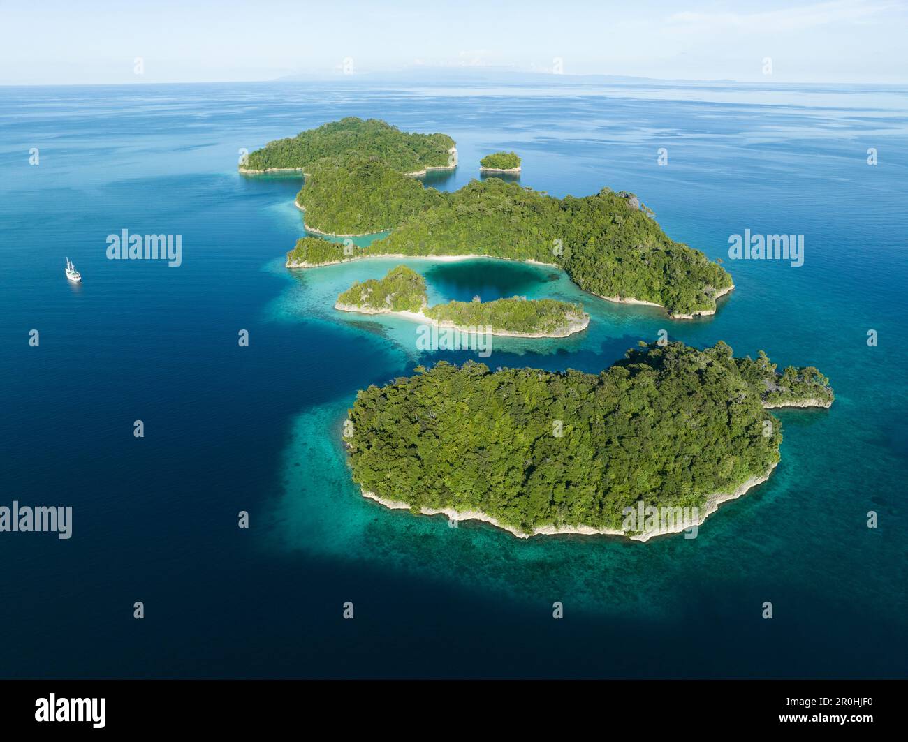 Coral reefs surround the rugged limestone islands that rise from West ...
