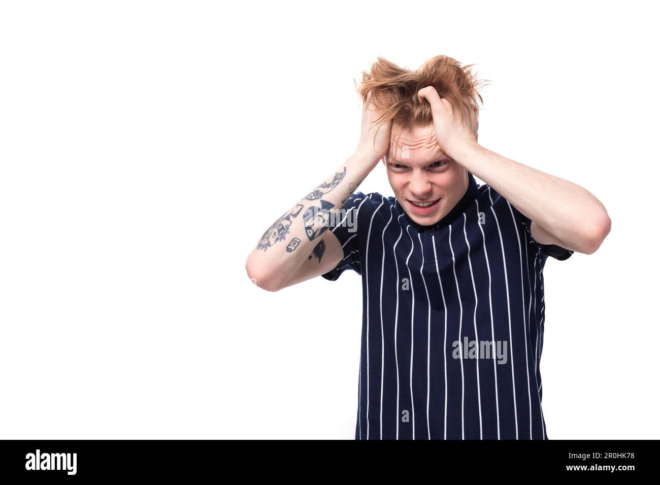 worried unhappy 25s blond man dressed in a tank top with tattoos ... worried unhappy 25s blond man dressed in a tank top with tattoos ...