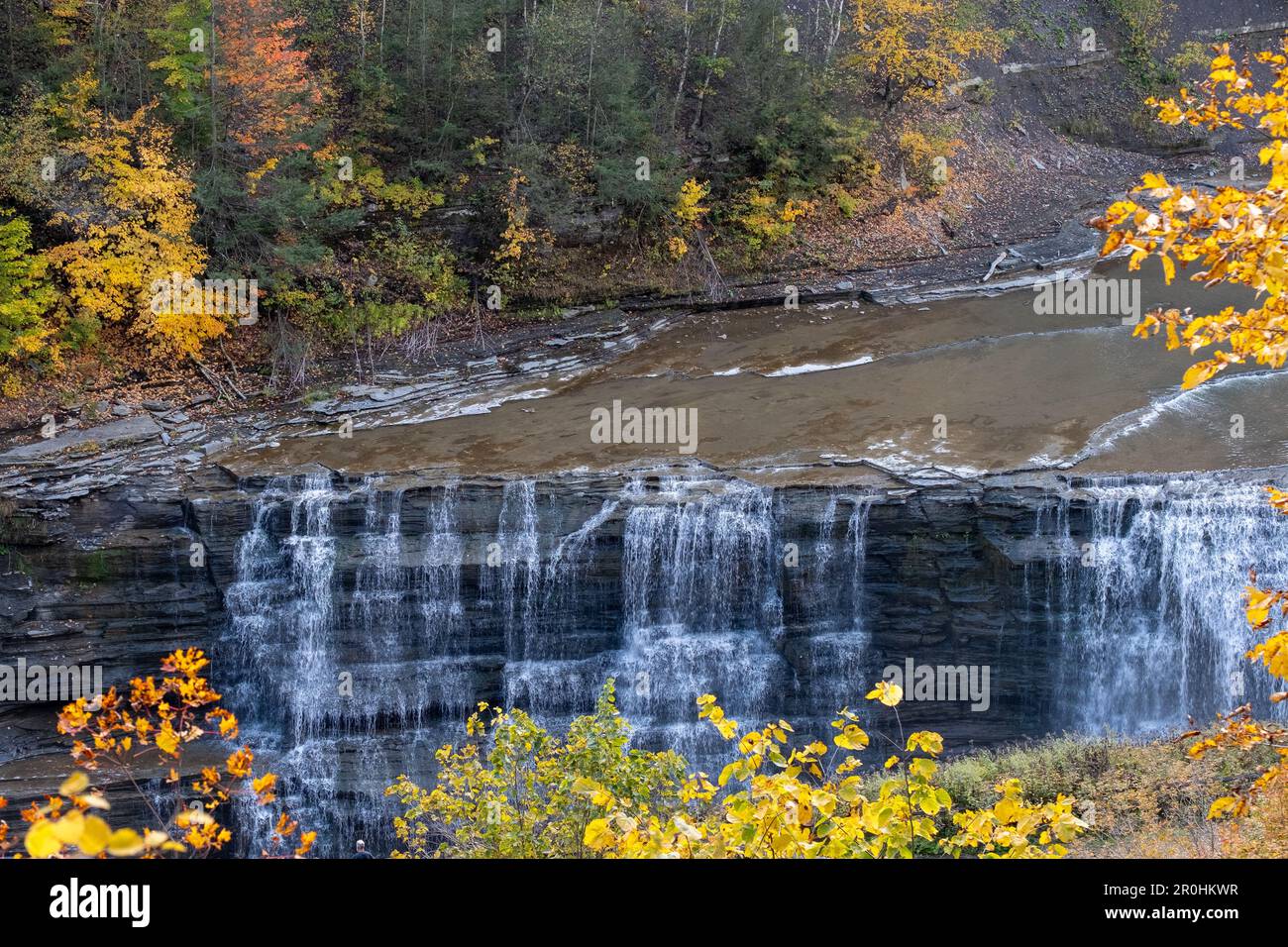 A serene waterfall cascading down a rocky cliffside in the Letchworth ...