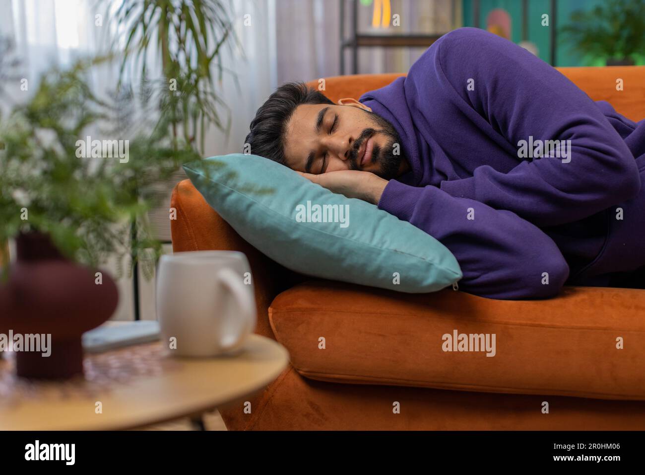 Tired indian man lying down in bed taking a rest. Carefree young hindu ...