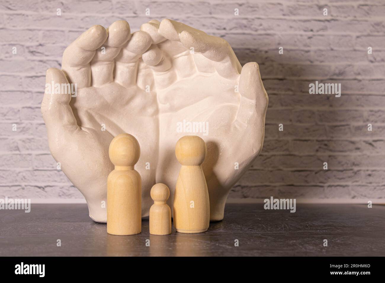 Housing for families. Close up of wooden figurines of family with ...