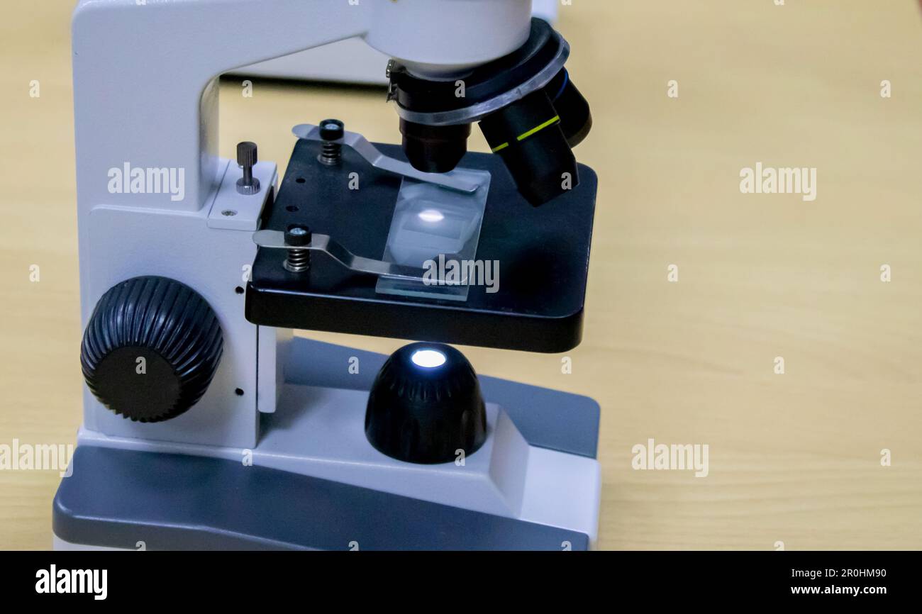 Microscope isolated on white, An old Soviet black-and-white microscope ...